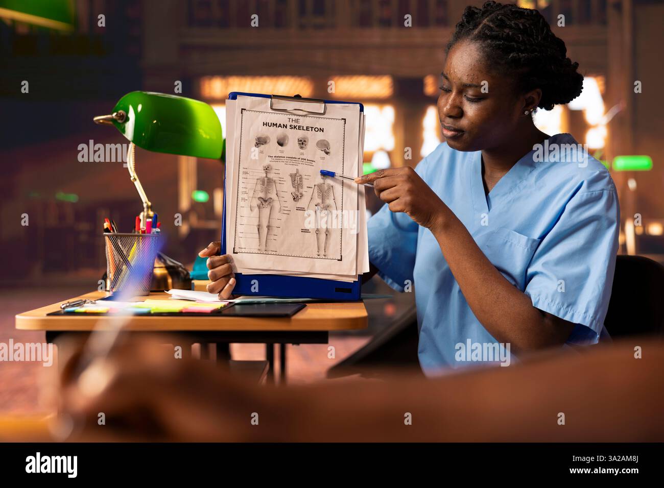 African American pupils studying together for med school exams, man and ...