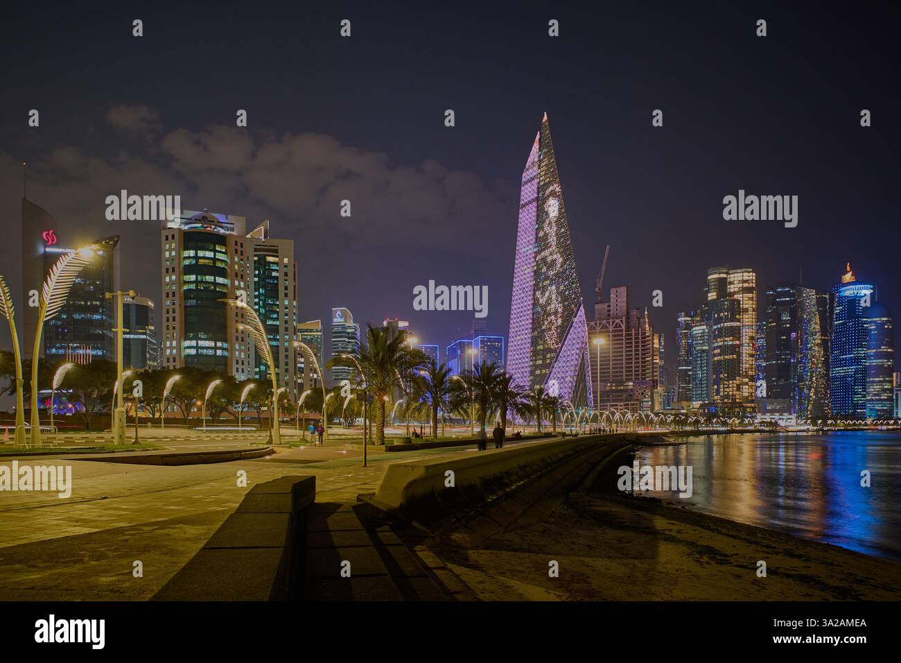 Doha Qatar skyline from corniche promenade at night in the West Bay ...