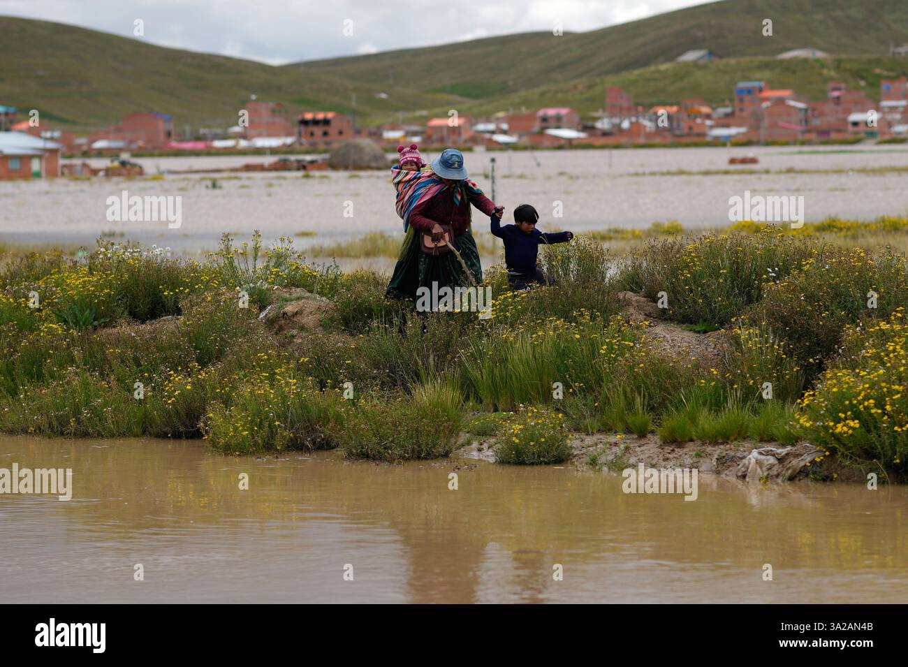 Residents traverse flooded grounds after the Pallina River overflowed ...