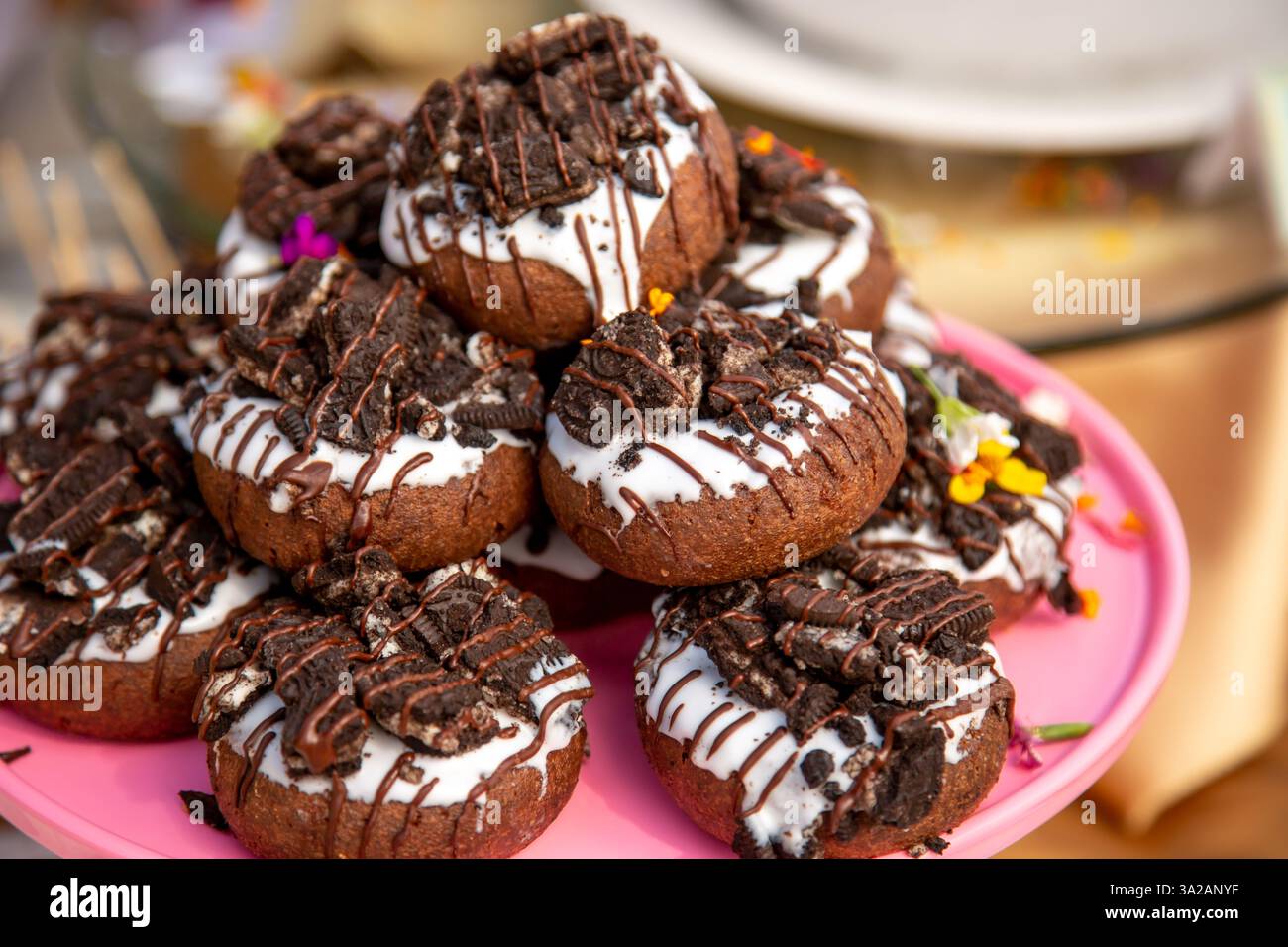 A view of a stack of cookie crumble mini donuts Stock Photo - Alamy