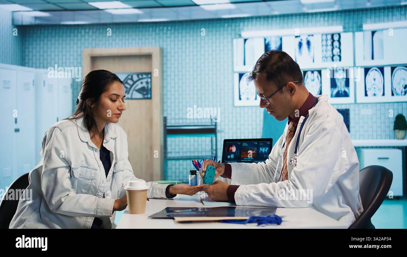 Indian physician prepares insulin pen for patient injection during a ...