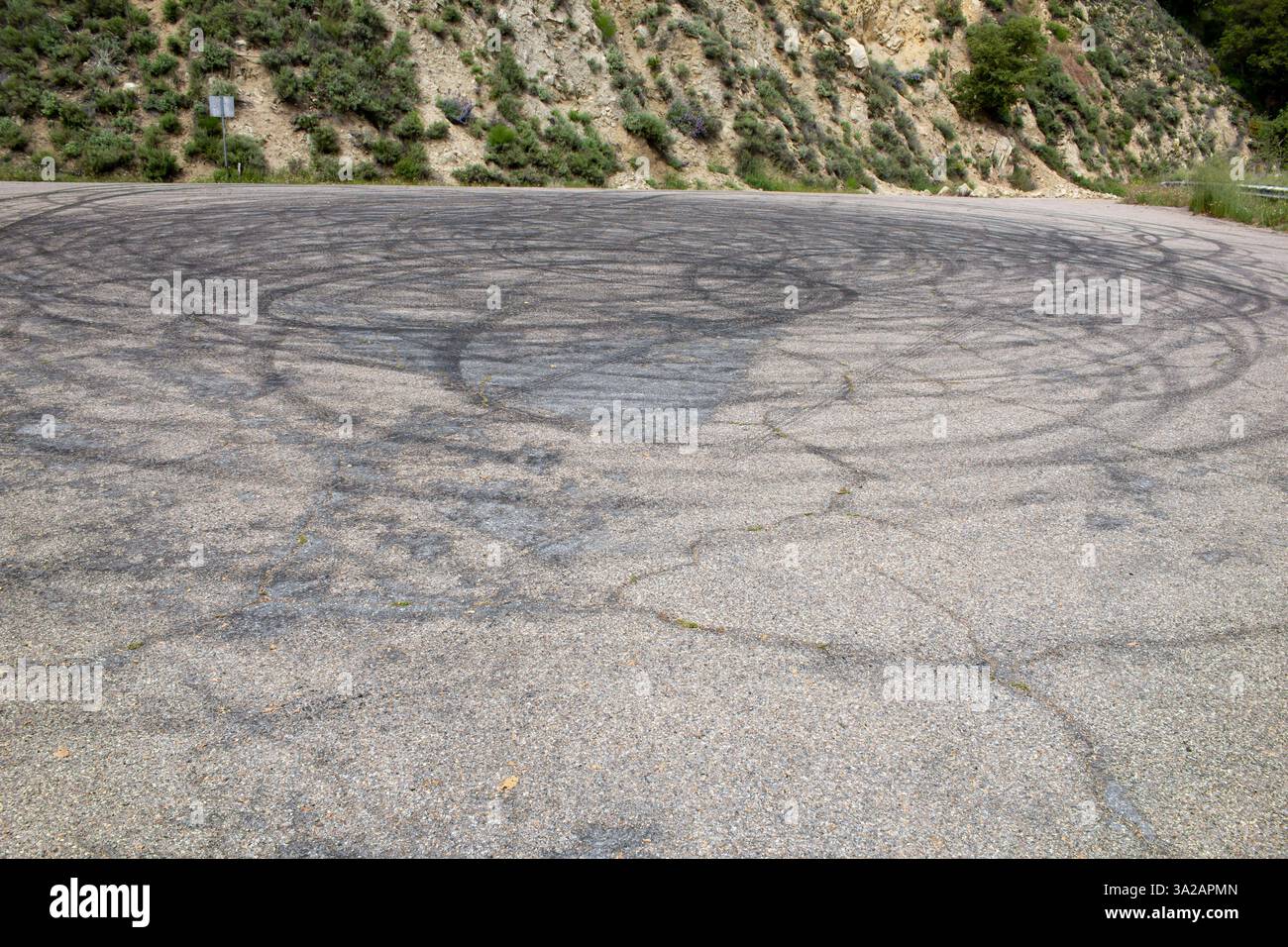 A view of motorcycle tire skid marks from a driver doing donut circles ...