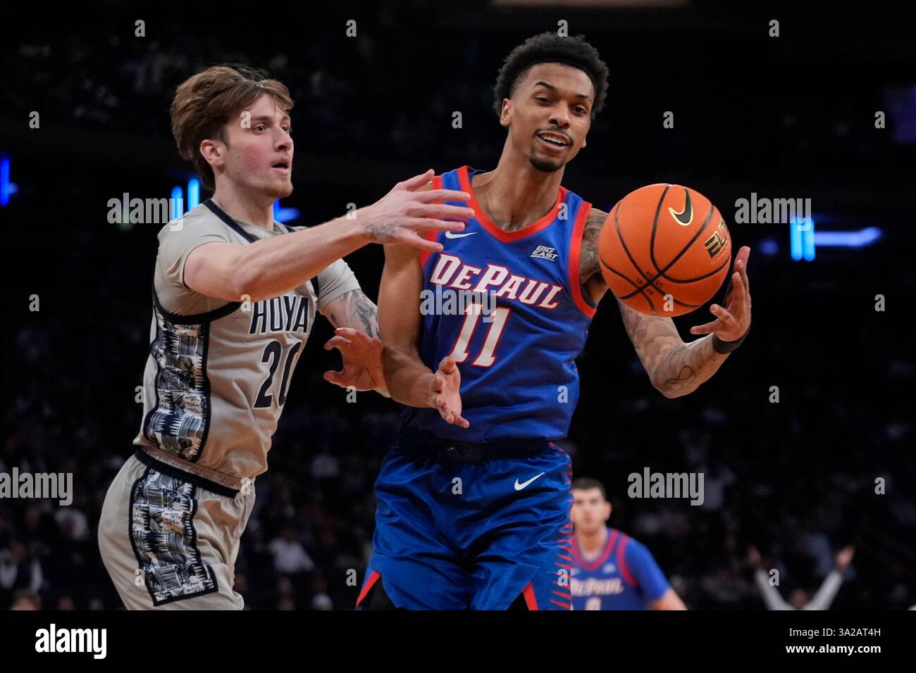 DePaul's CJ Gunn (11) fights for control of the ball with Georgetown's ...