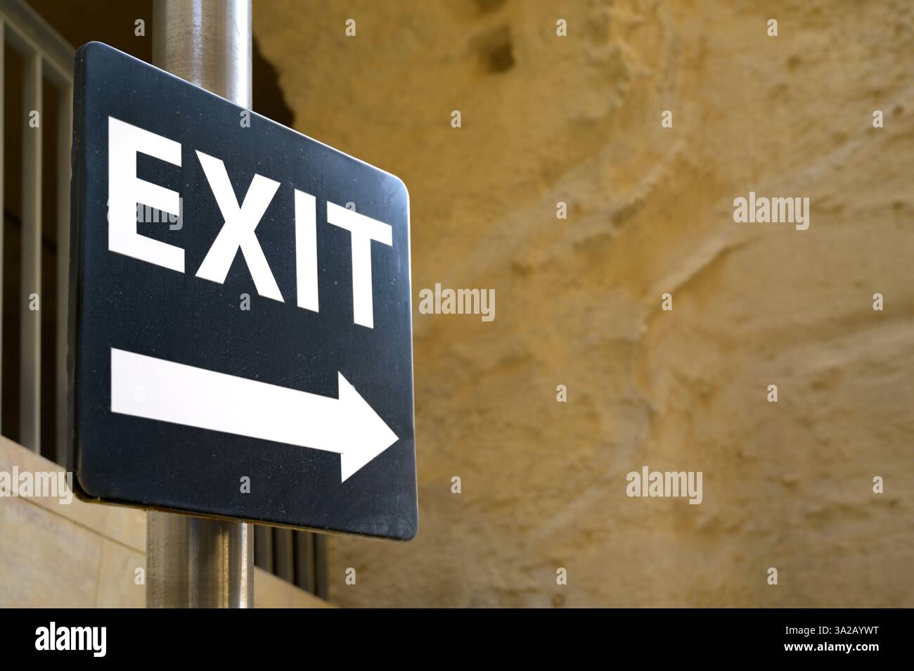 Exit sign with arrow pointing right, white letters on black background ...