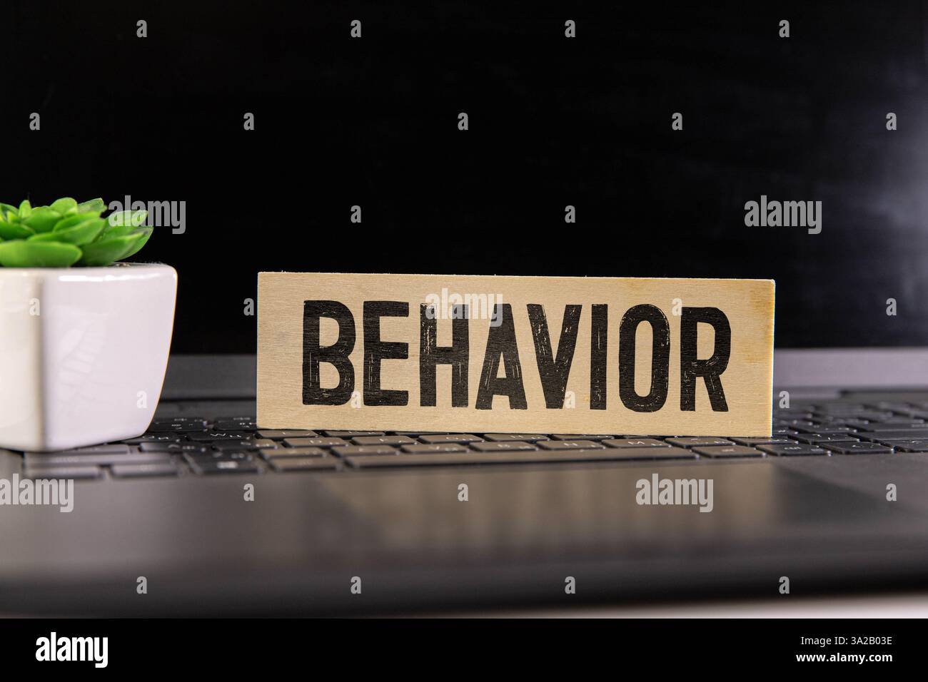 BEHAVIOR Word made of building blocks on a light yellow background, the ...