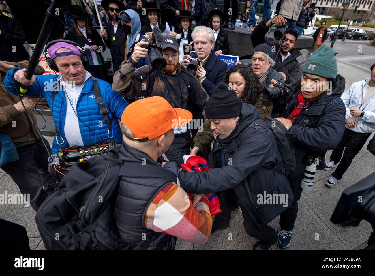 NEW YORK, NEW YORK - MARCH 12: Protestors fight over a Trump flag as ...