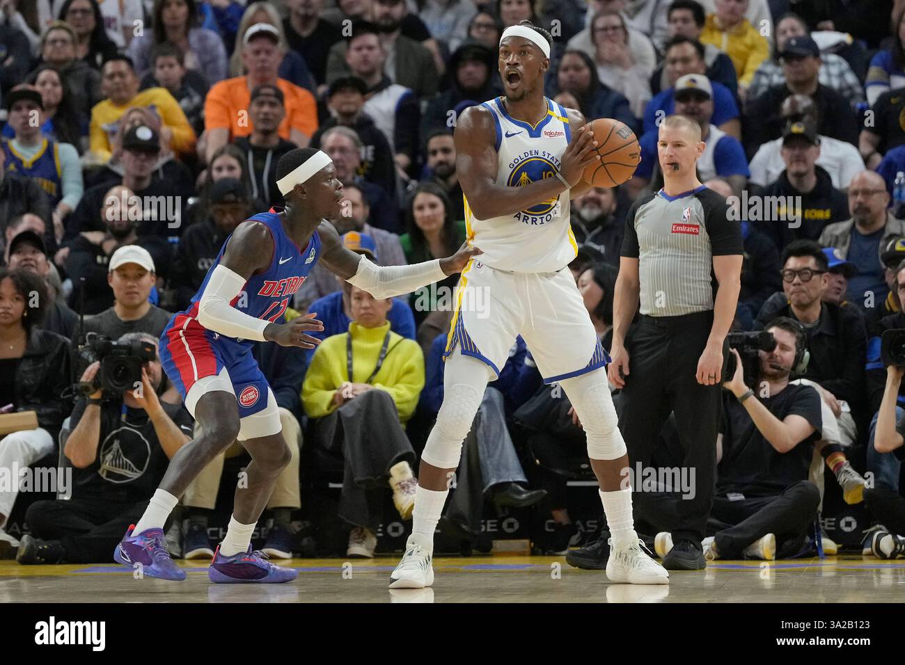 Golden State Warriors forward Jimmy Butler III, right, looks to pass the ball while being ...