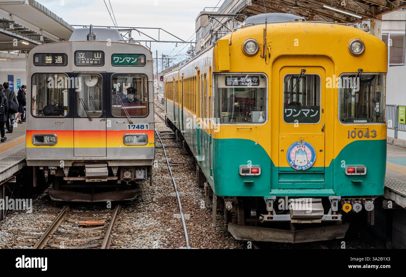 A Toyoma Chiho Railway 17480 Series train arrives next to a 10030 ...