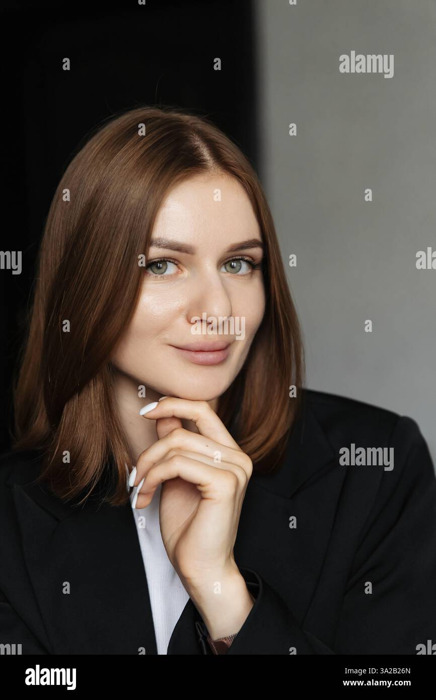 A stylish young woman confidently poses in chic and sophisticated ...