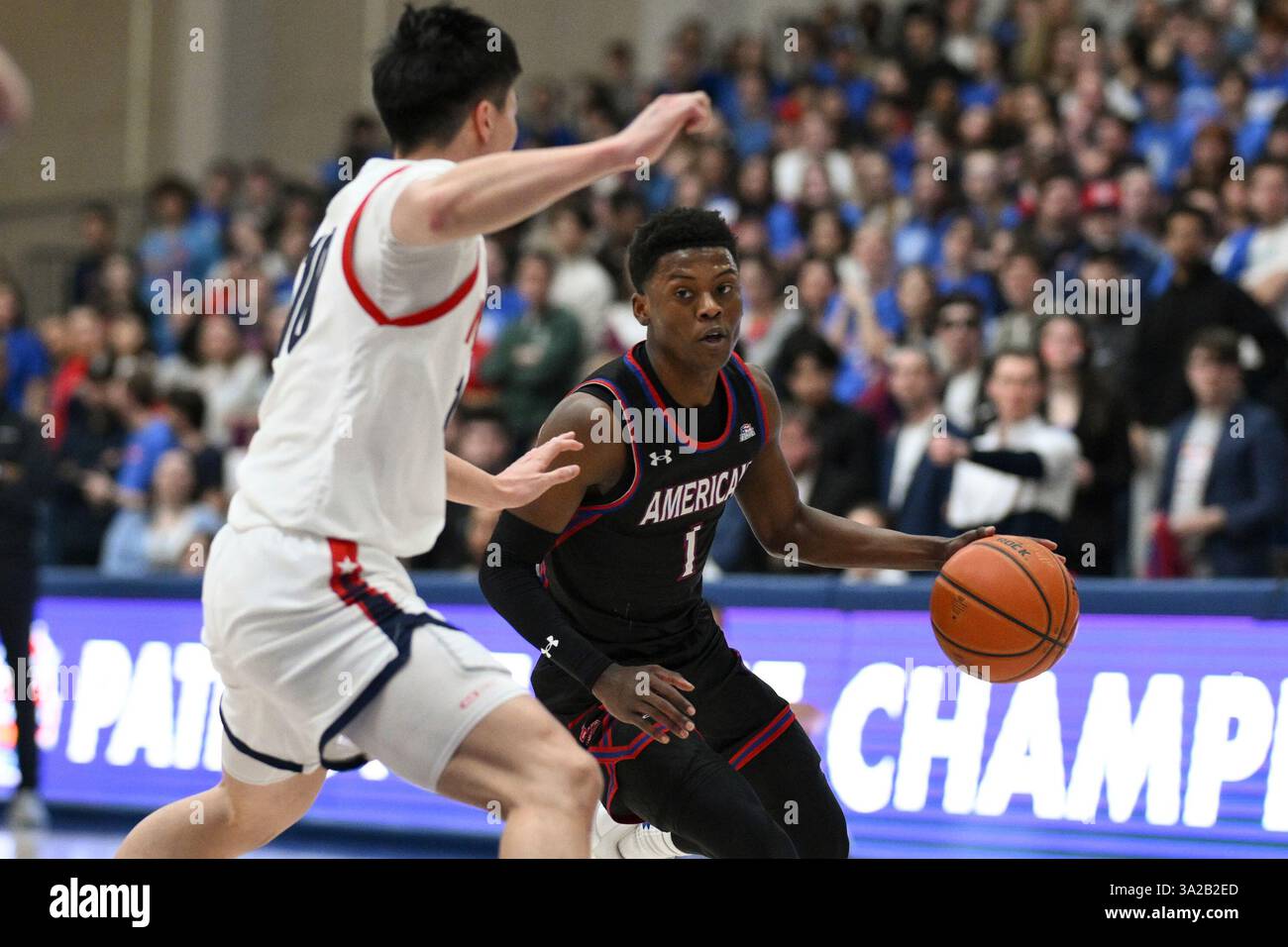 American guard Elijah Stephens (1) handles the ball as Navy guard ...