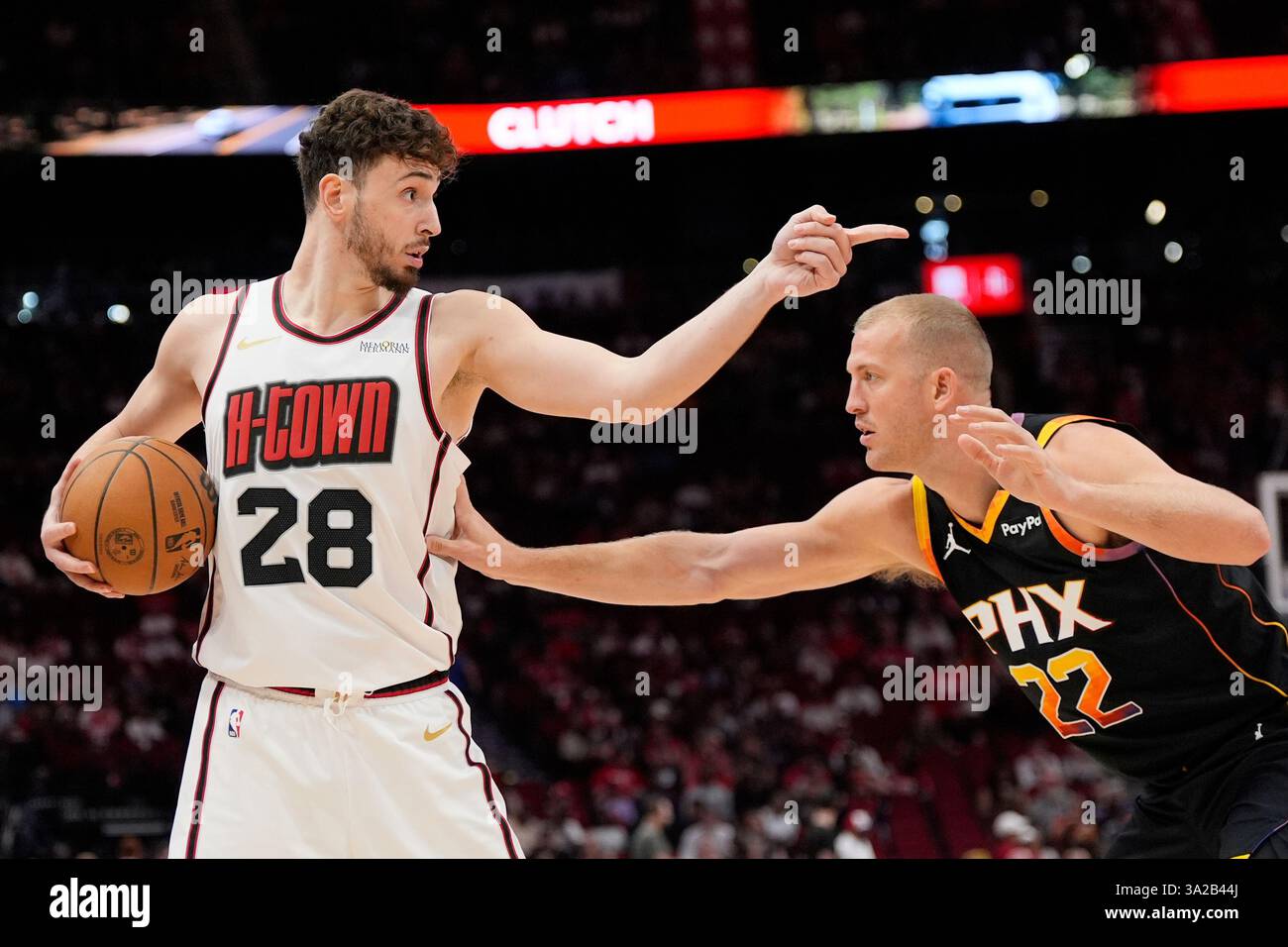 Houston Rockets' Alperen Sengun (28) points over Phoenix Suns' Mason Plumlee (22) during the ...