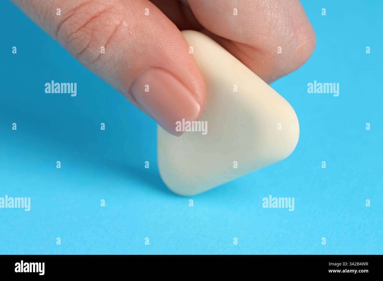 Woman using eraser on light blue background, closeup Stock Photo - Alamy