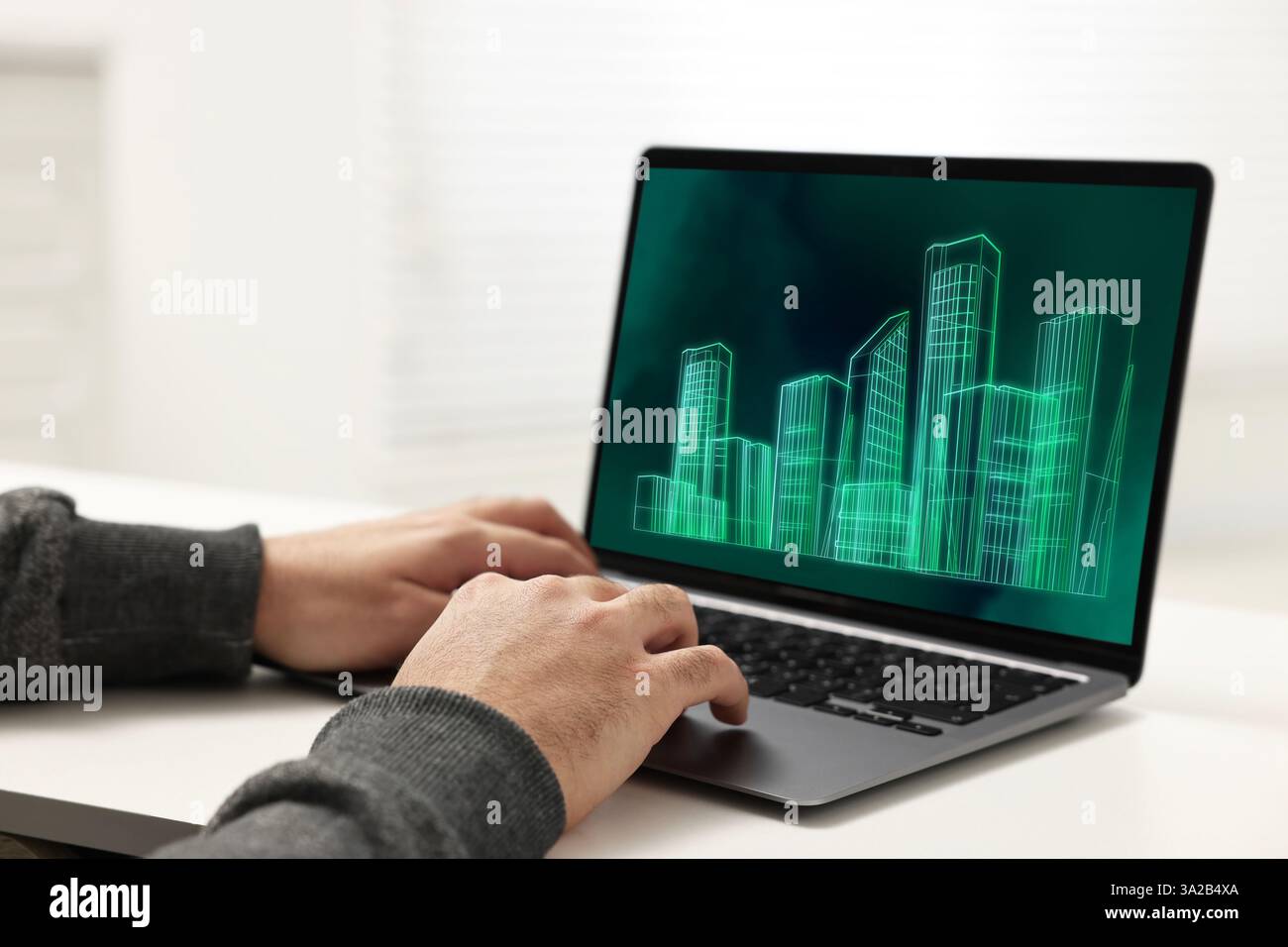 Building information modeling. Man working at laptop indoors, closeup ...