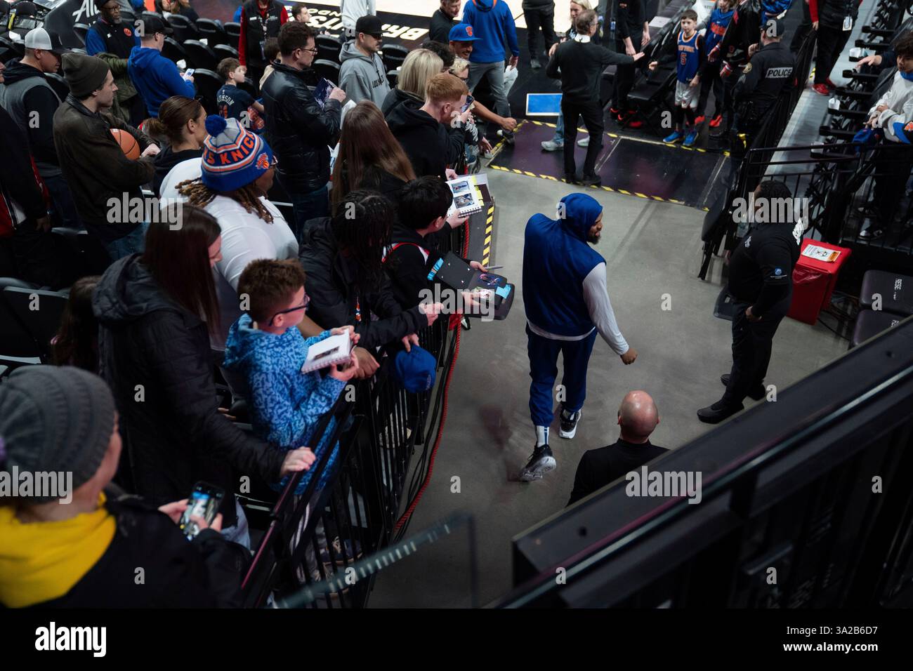 Fans watch as New York Knicks center Karl-Anthony Towns walks to the ...