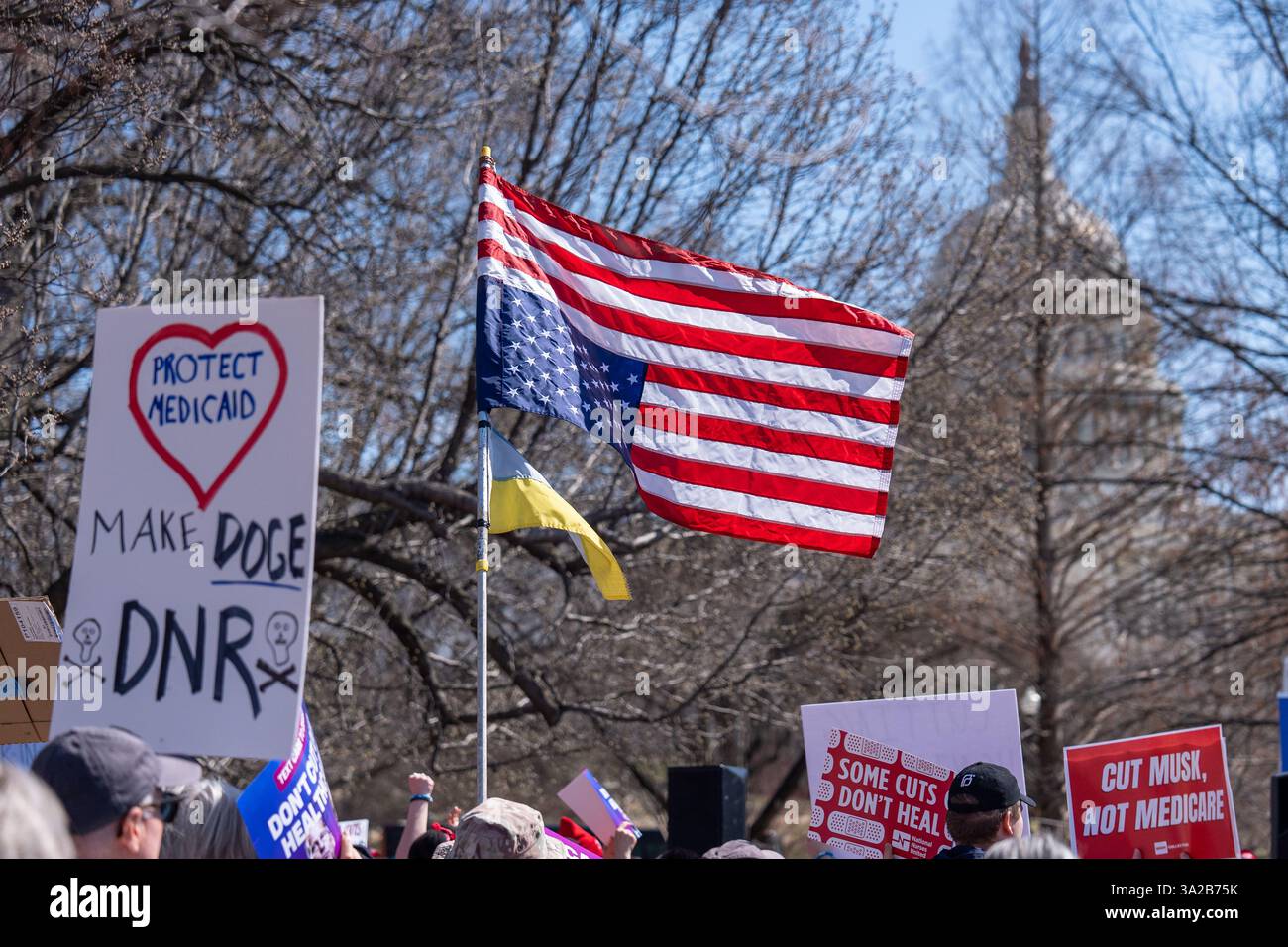 People hold signs and wave flags during a demonstration at the U.S ...