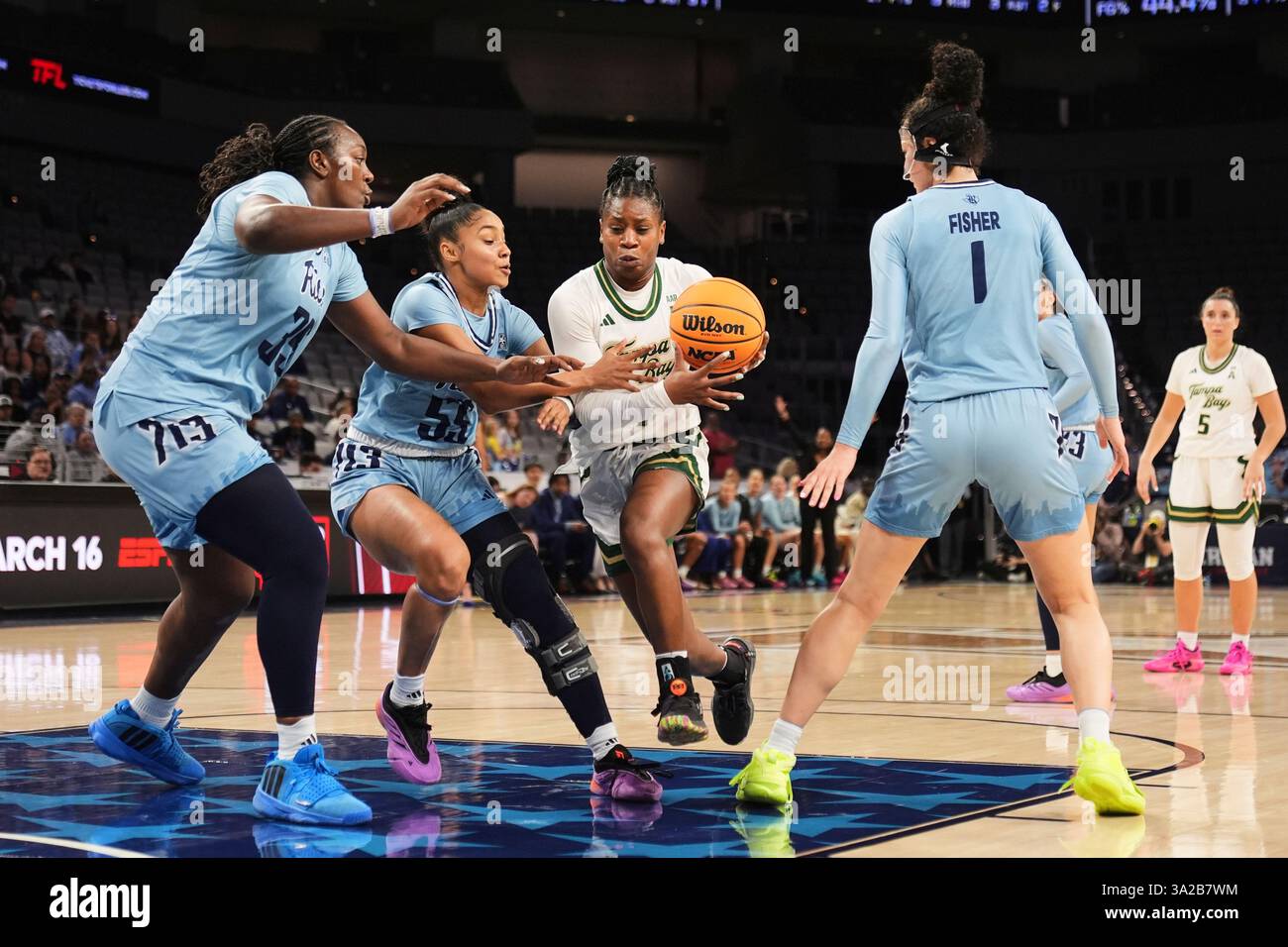 South Florida's Mama Dembele, center, drives to the basket as Rice's ...
