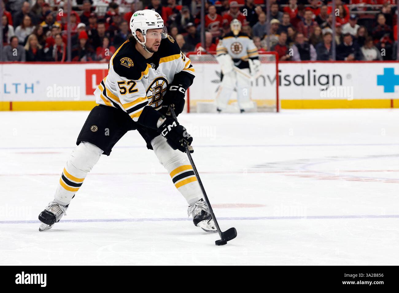 Boston Bruins' Andrew Peeke (52) skates with the puck against the ...