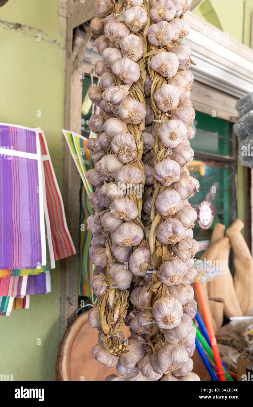 Garlic ropes hang outside in front of a store in Nuevo Progreso, Mexico ...