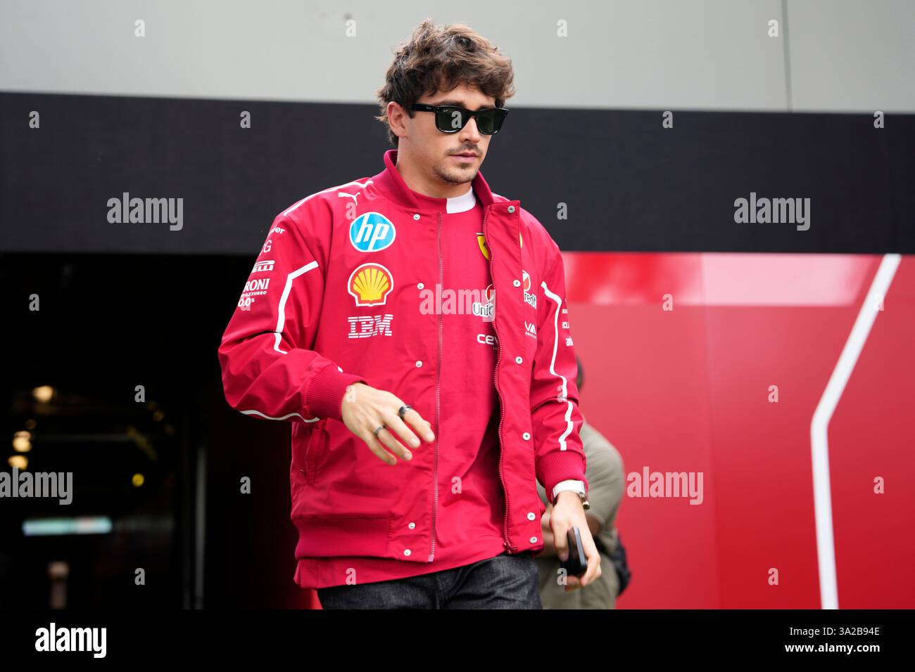 Ferrari driver Charles Leclerc of Monaco walks from his team garage ...