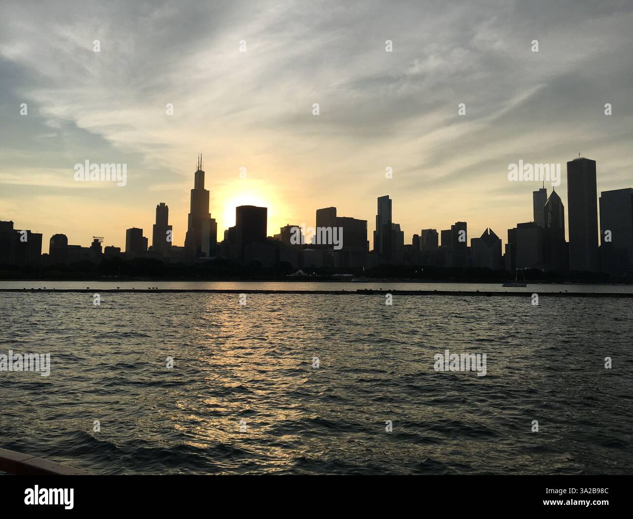 Chicago skyline at sunset, viewed from Lake Michigan with golden ...