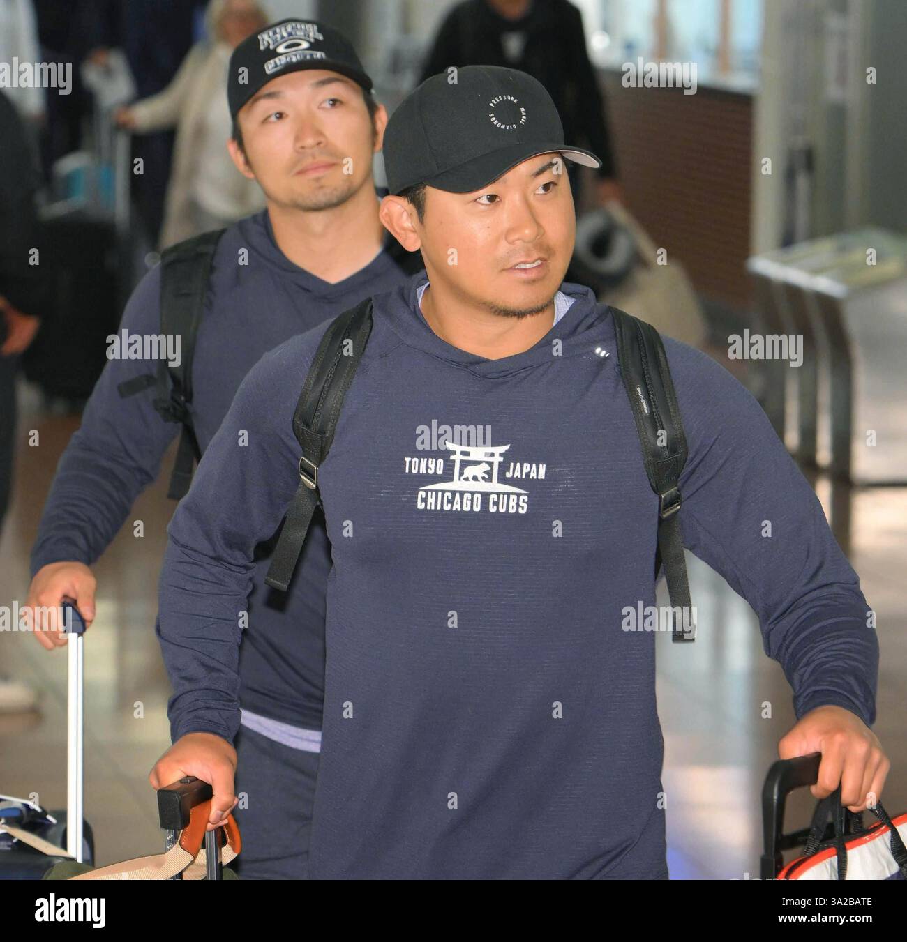 Shota Imanaga (front) and Seiya Suzuki of the Chicago Cubs arrive at Tokyo's Haneda airport on ...
