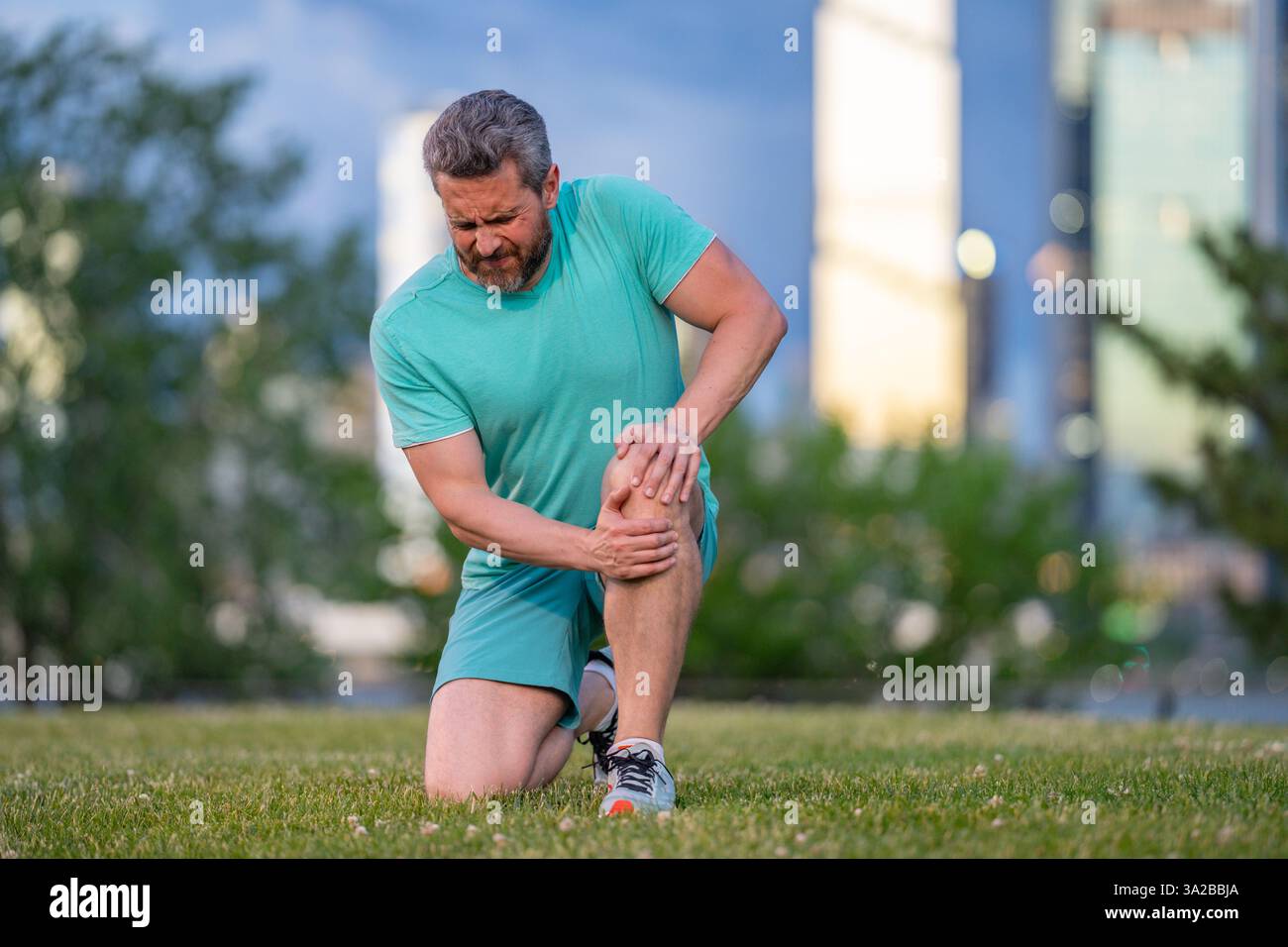 Pain after sport. Athletic man suffering from knee pain. Injured man ...