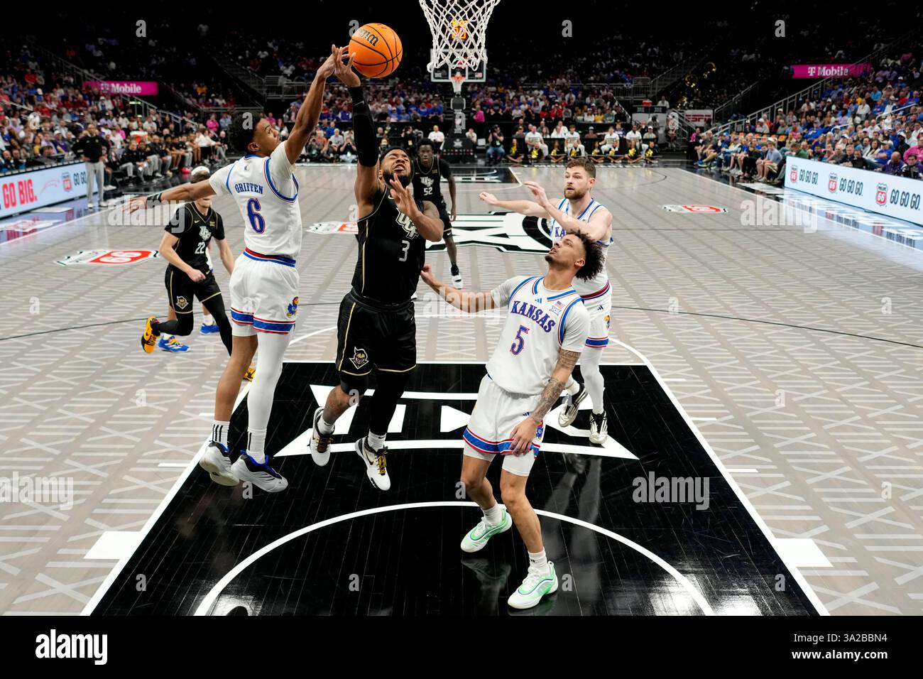 UCF guard Darius Johnson (3) shoots between Kansas guards Rylan Griffen ...