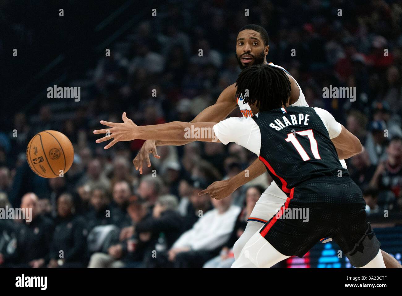 New York Knicks forward Mikal Bridges tries to pass the ball around ...