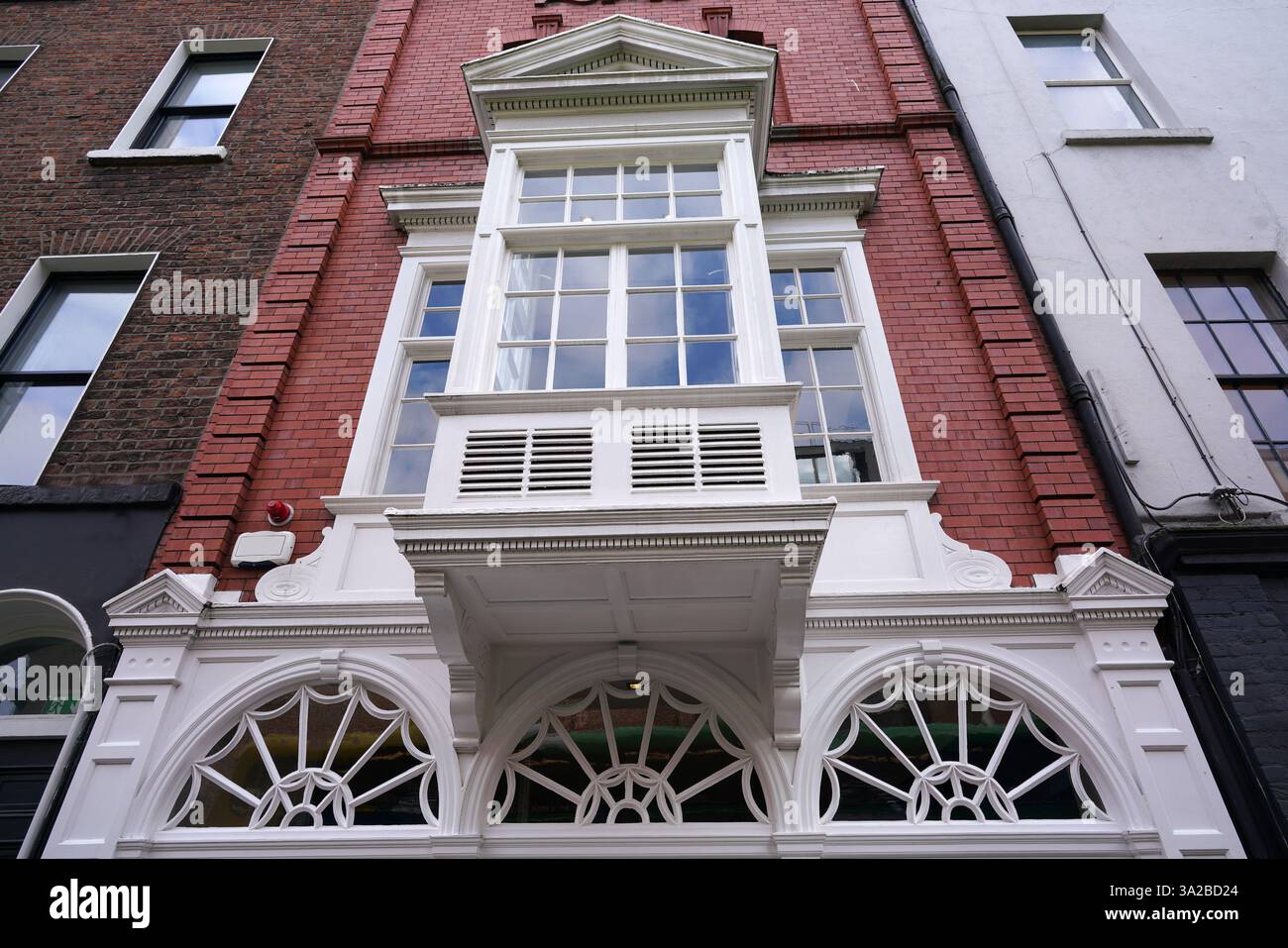 Vintage with projecting bay window above fanlight windows Stock Photo ...