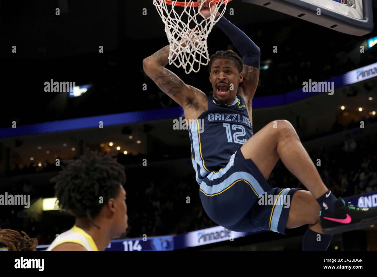 Memphis Grizzlies guard Ja Morant (12) hangs on the rim as he pleads ...