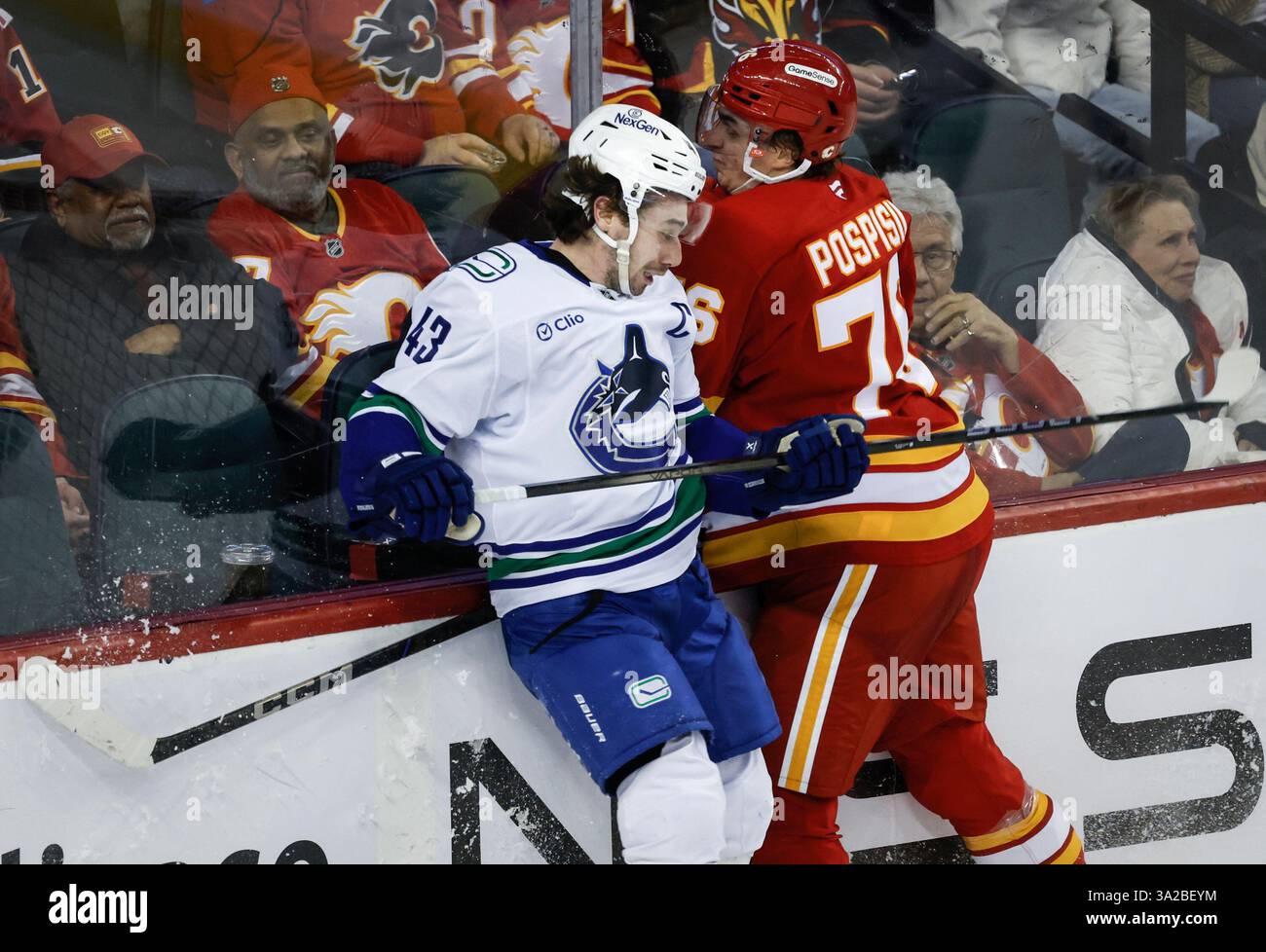 Vancouver Canucks' Quinn Hughes, left, checks Calgary Flames' Martin ...