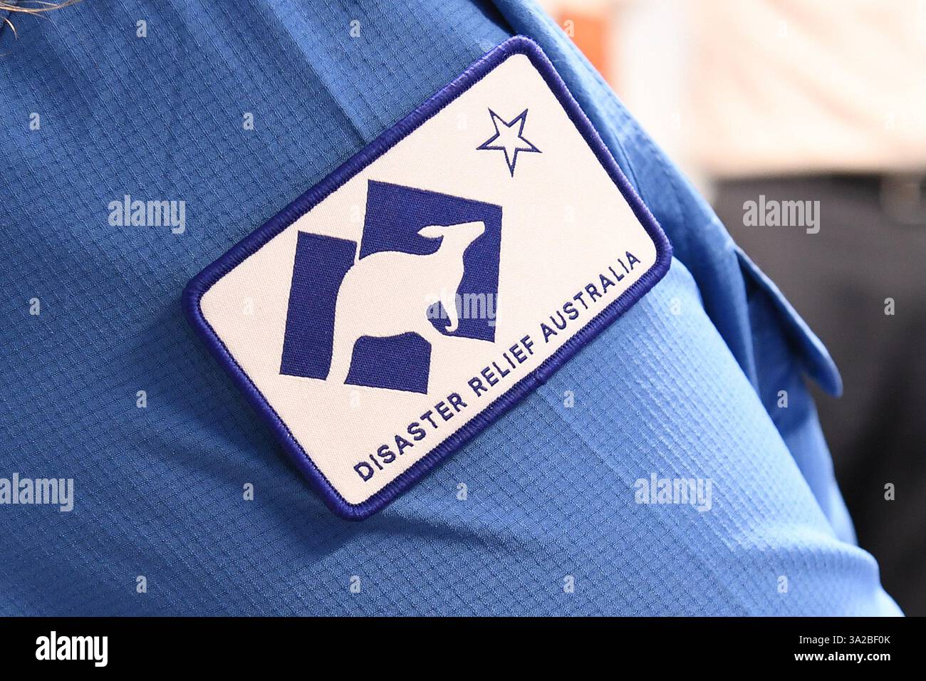 A Disaster Relief Australia badge is seen in Hendra before a doorstop ...