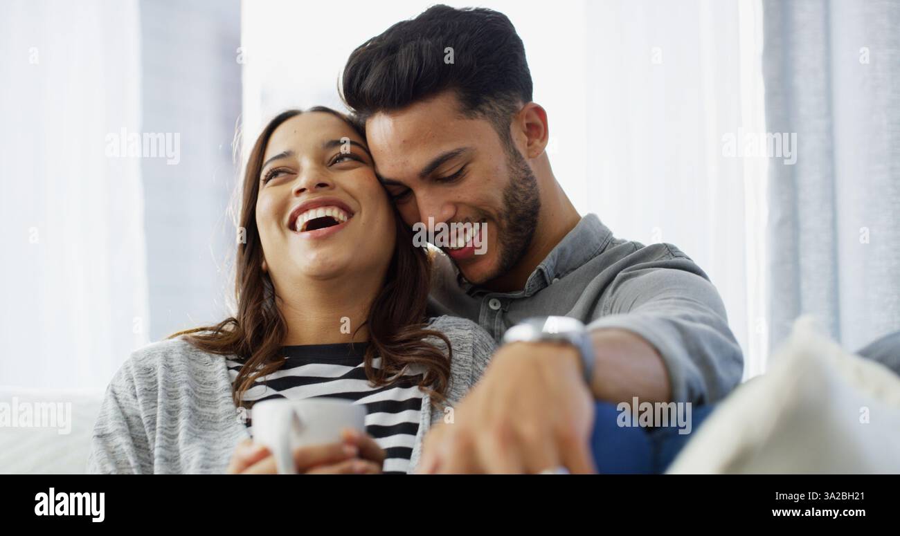 Romance, laughing and couple with coffee, home and love in living room ...