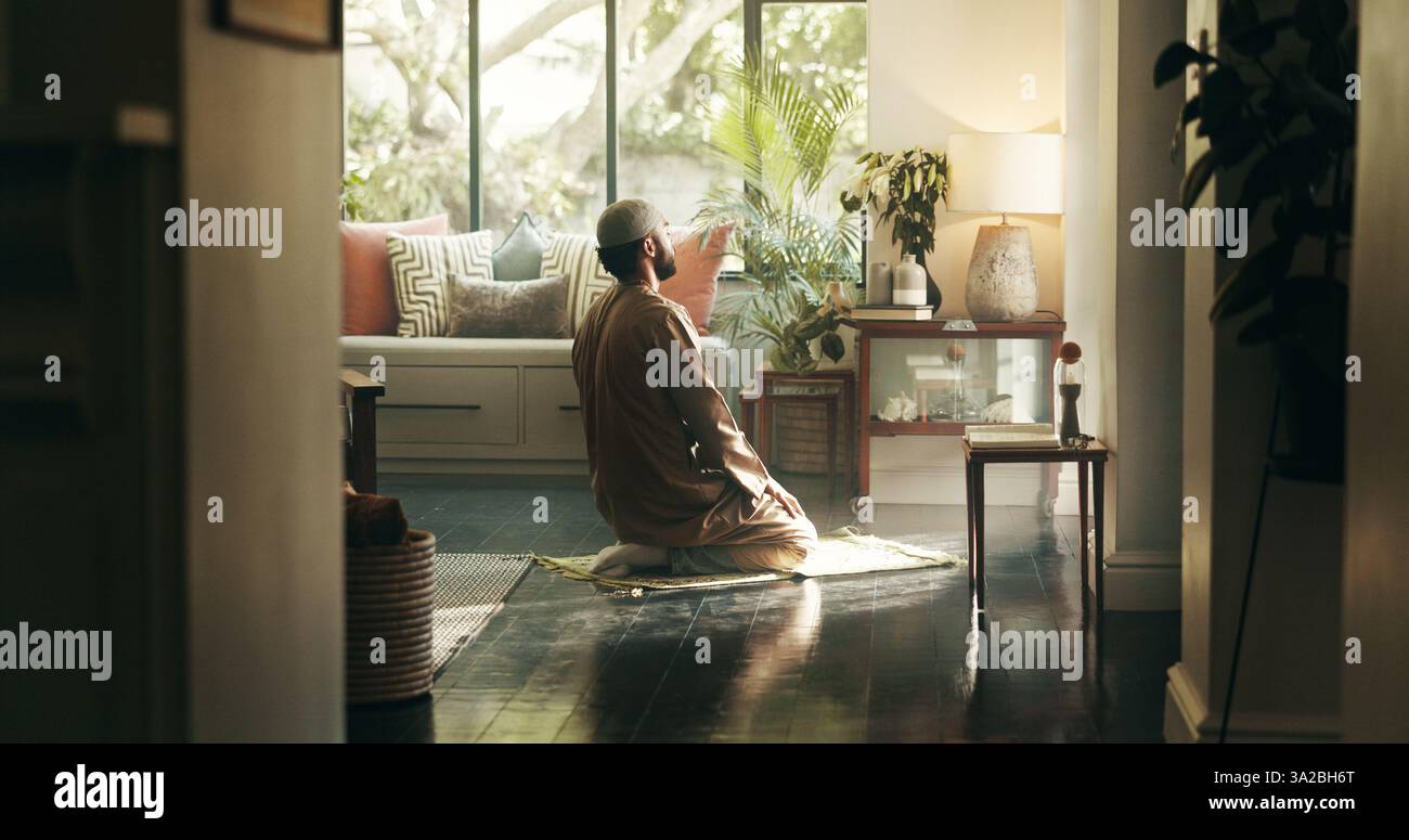 Islam, man and kneeling in prayer in home for spiritual worship, praise ...