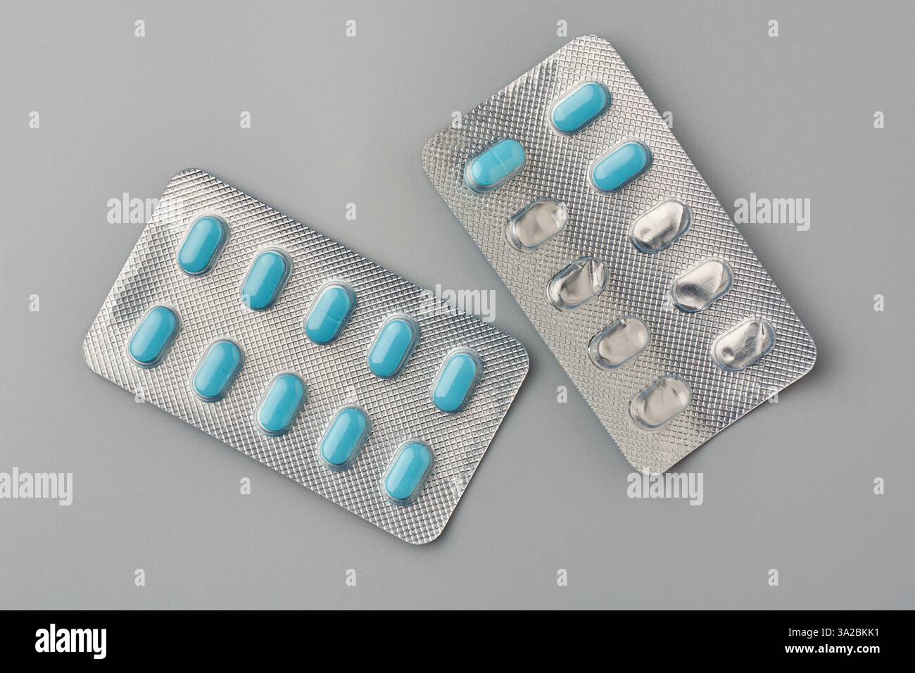 close-up of light blue color tablets in blister pack with empty ...