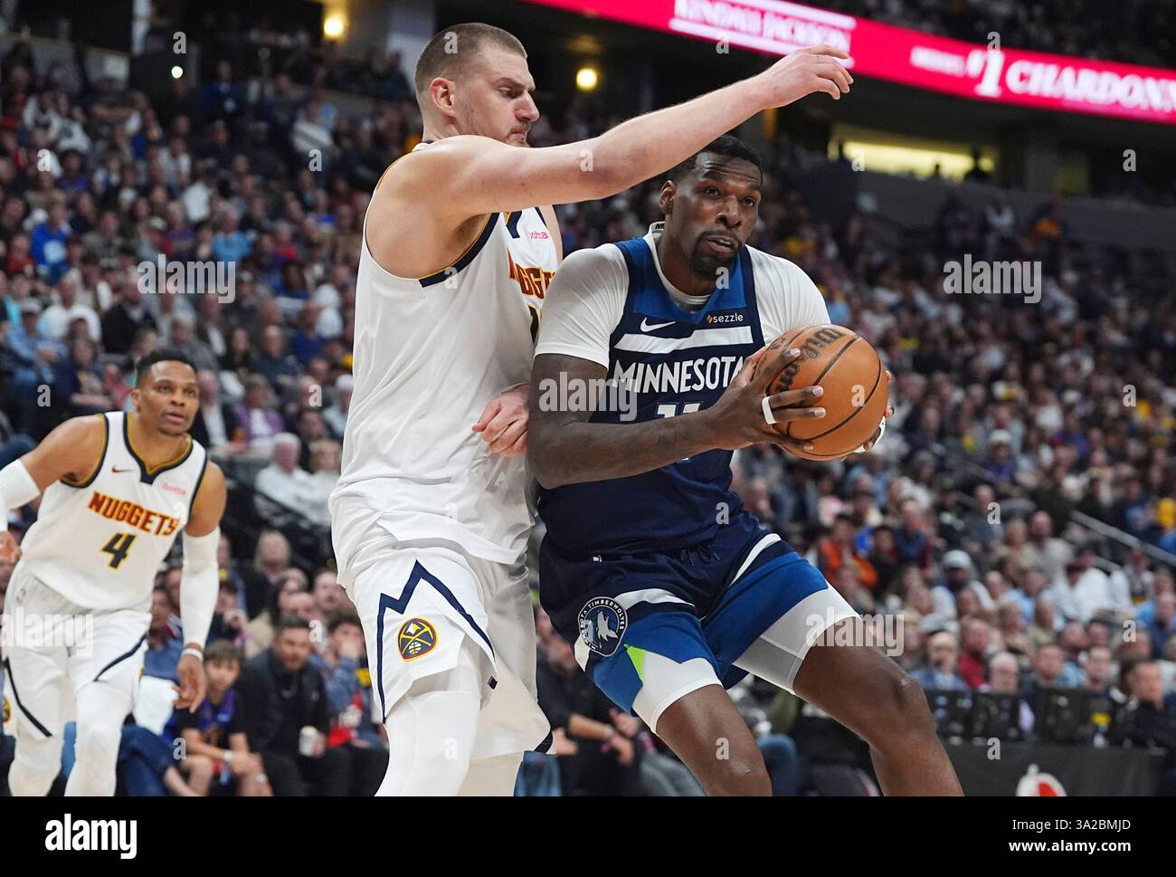 Minnesota Timberwolves center Naz Reid, right, drives the lane as ...