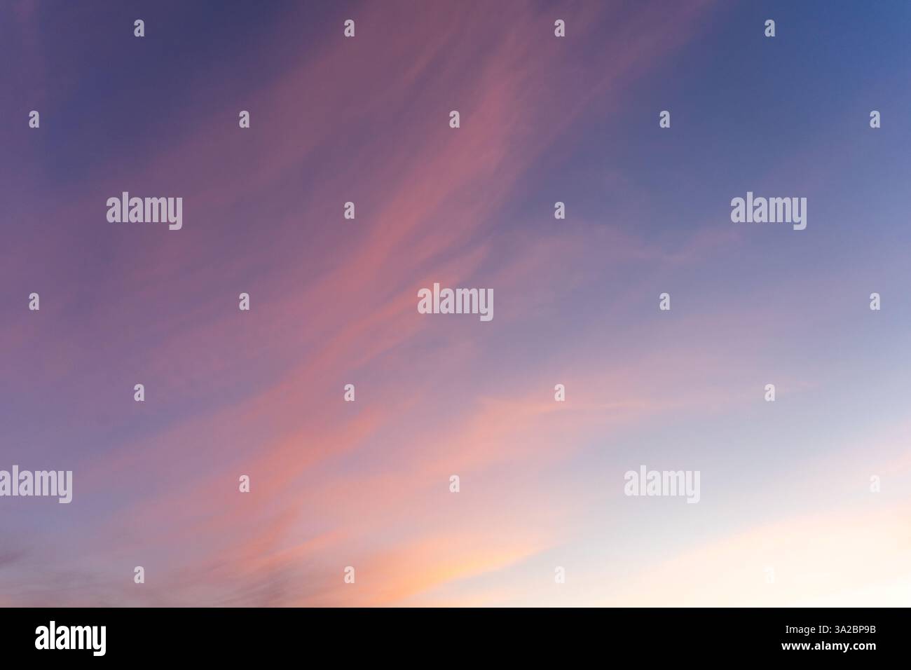 A breathtaking sunset displays pastel colors washing over the sky ...