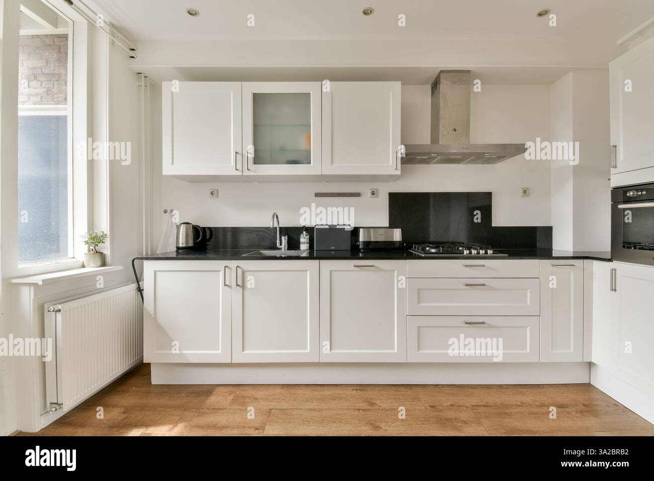 A sleek and contemporary kitchen equipped with modern appliances and a ...