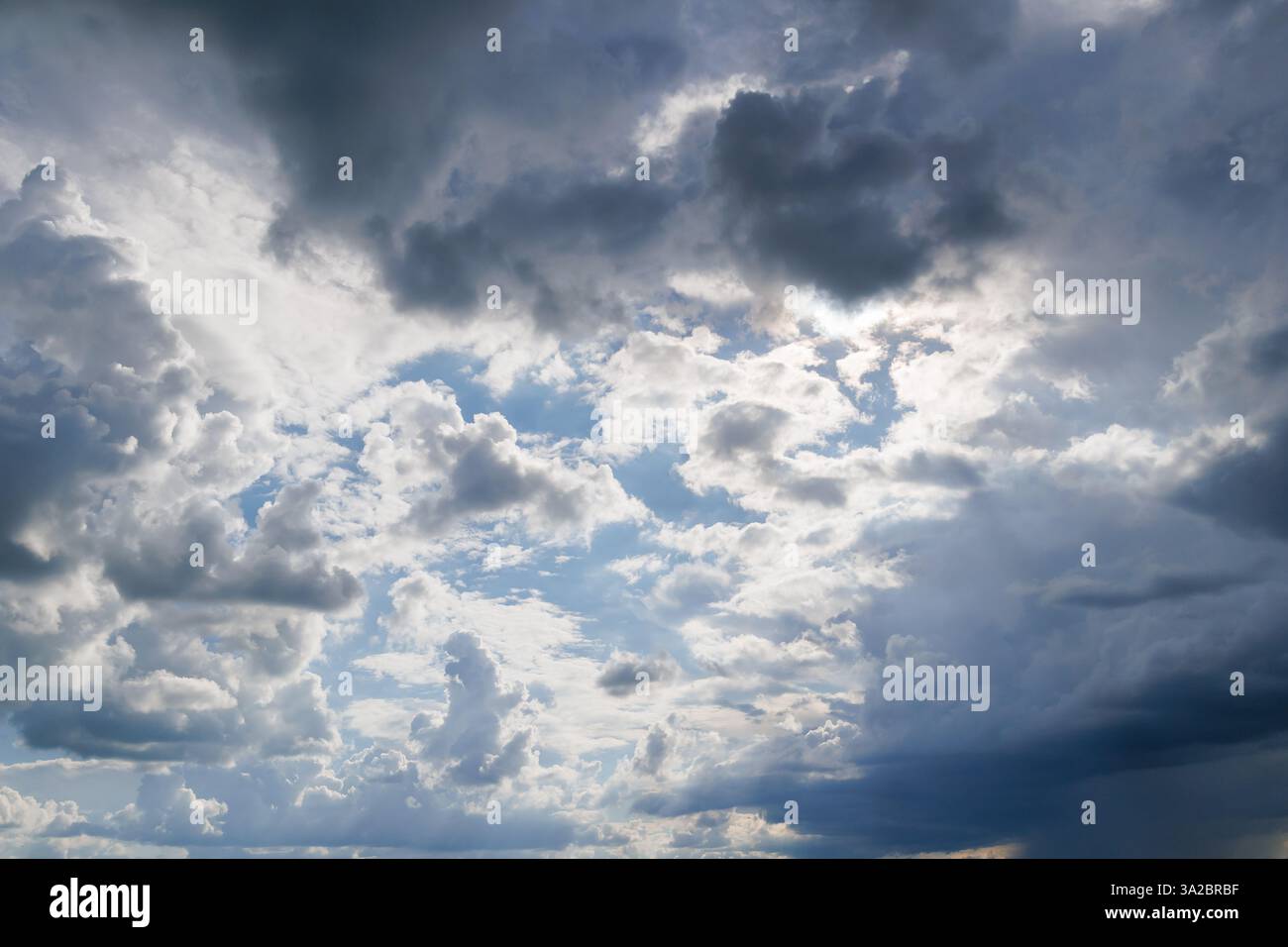 A scenic sky filled with a mix of dark and fluffy clouds, creating a ...