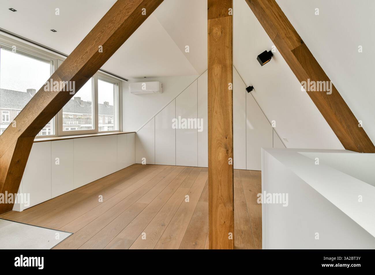A stylish and minimalist interior showcasing wooden beams and a ...