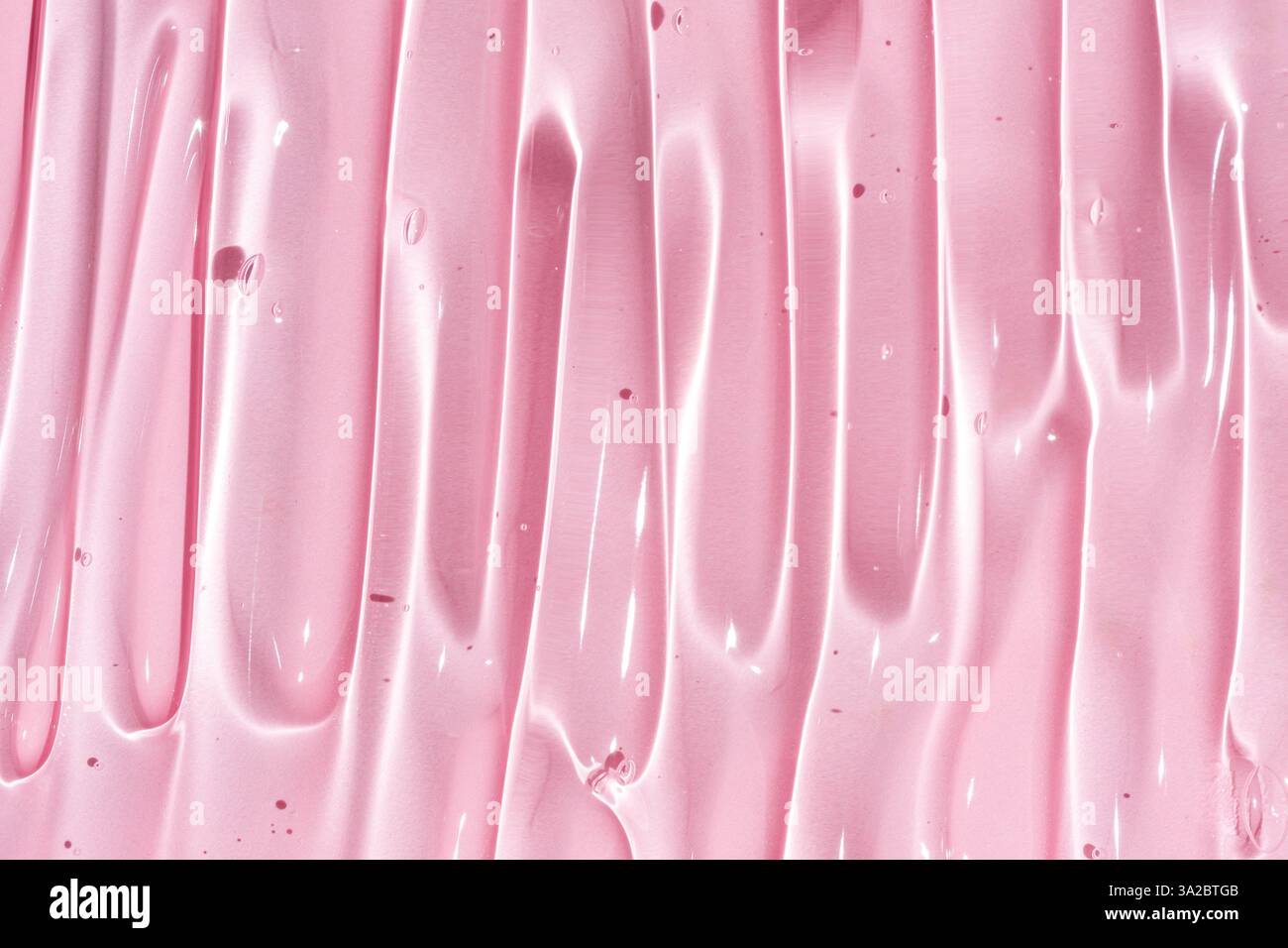 Close up gel texture of cosmetic products. transparent cream on a pink ...