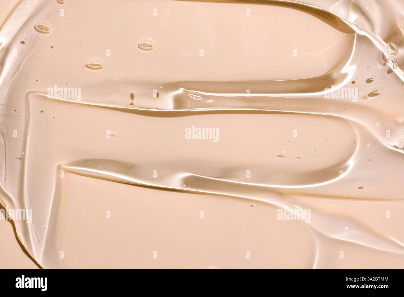 Close up gel texture of cosmetic products. transparent cream on a beige ...