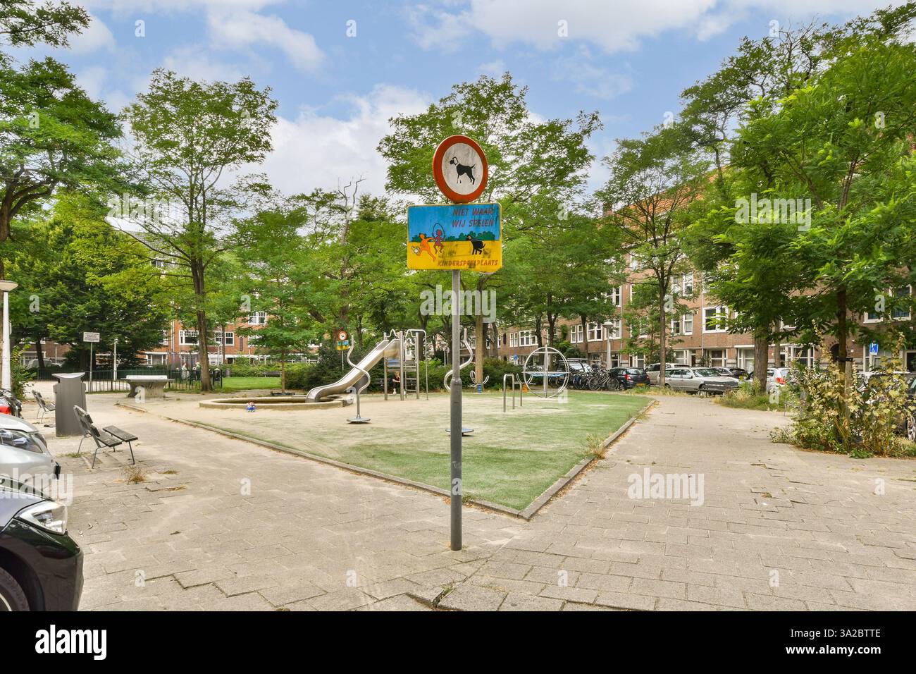 A vibrant playground stands amidst lush greenery, featuring a slide and ...