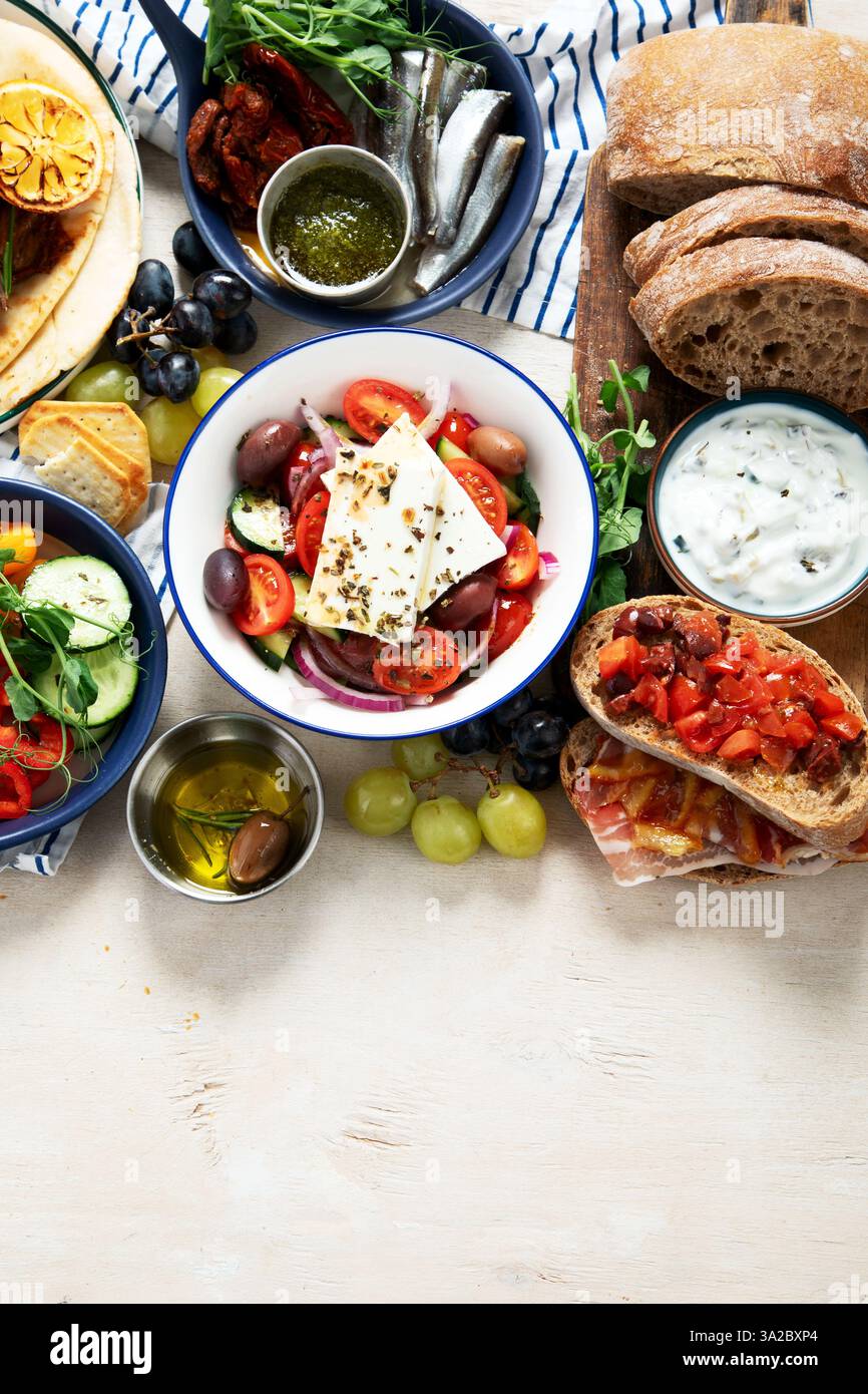 Greek food background. Fsh, pita, greek salad, tzatziki, feta, olives ...