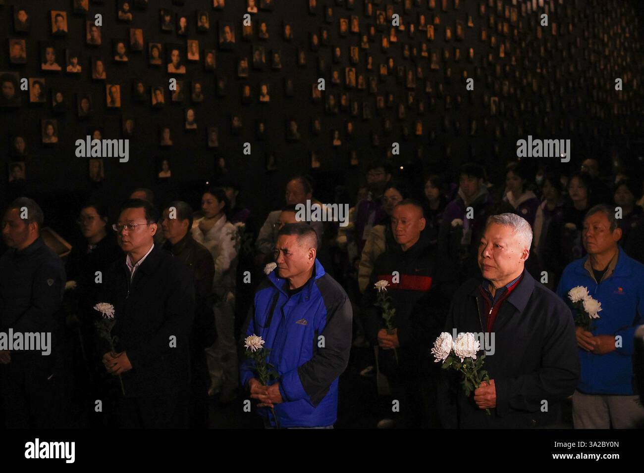Nanjing,China.11th March 2025. Mourners attend a "lights out" mourning ...