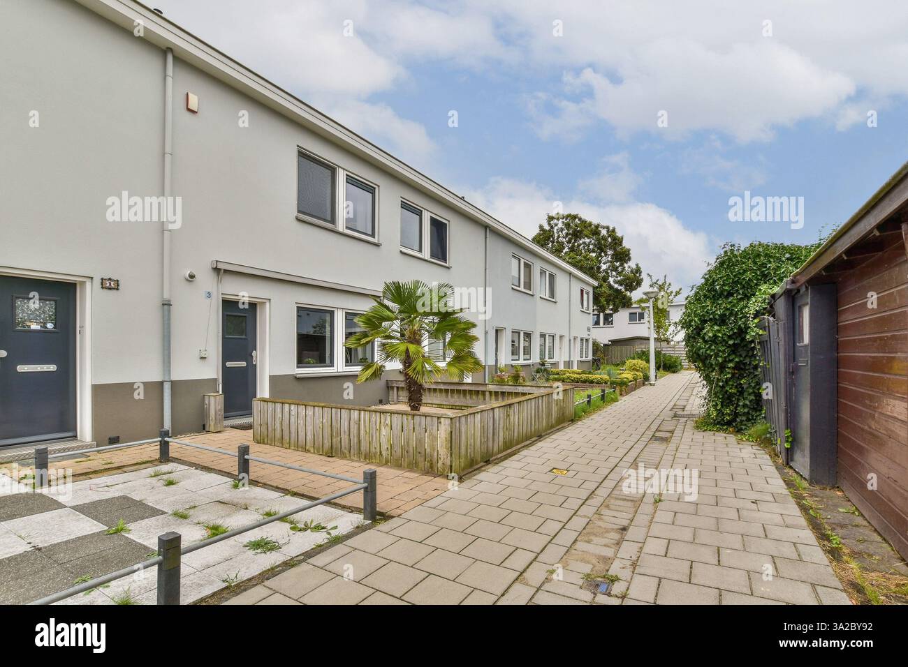 A view of modern residential buildings alongside a clean pathway and ...