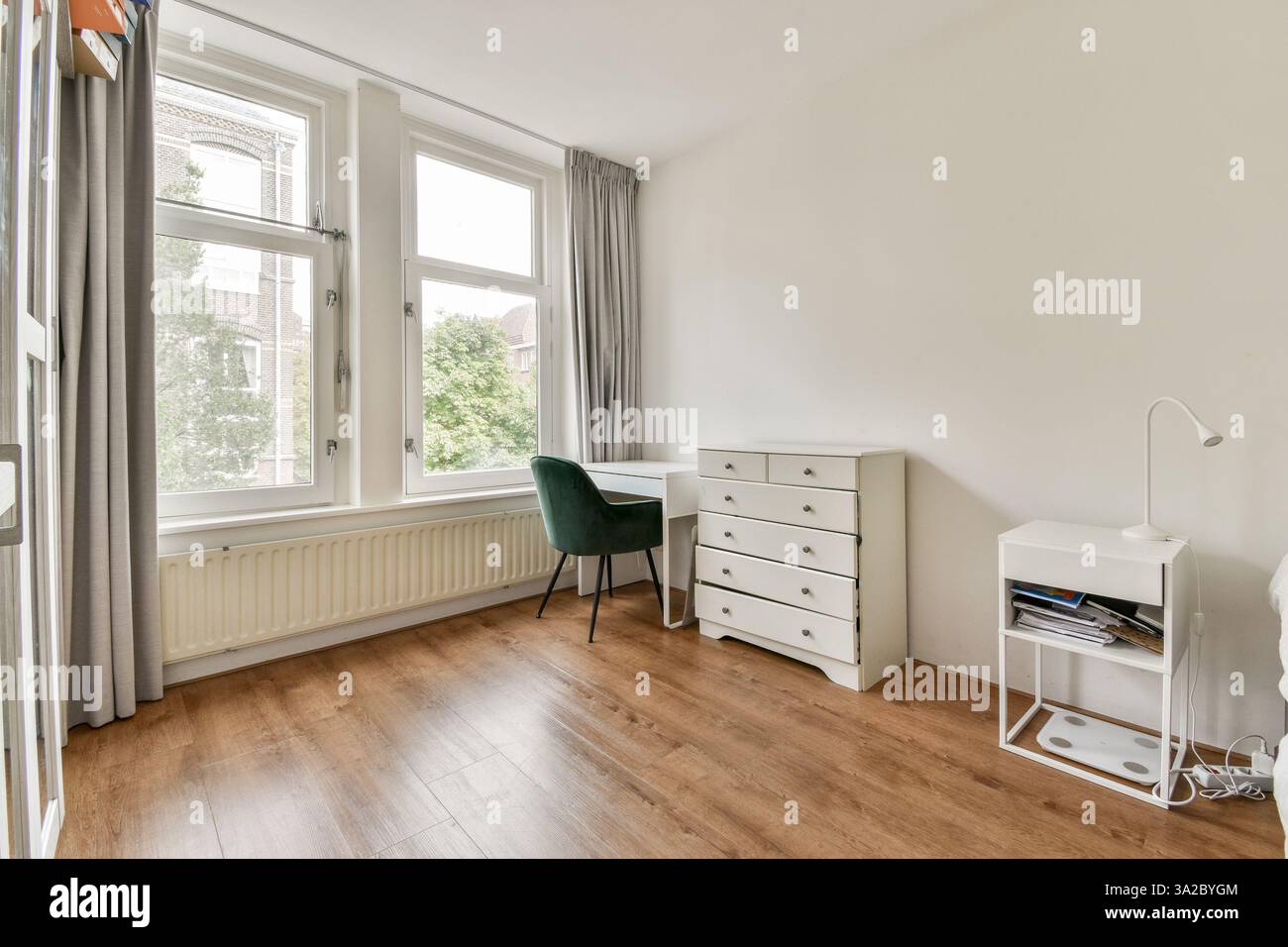 A spacious, minimalist bedroom featuring large windows, natural light ...