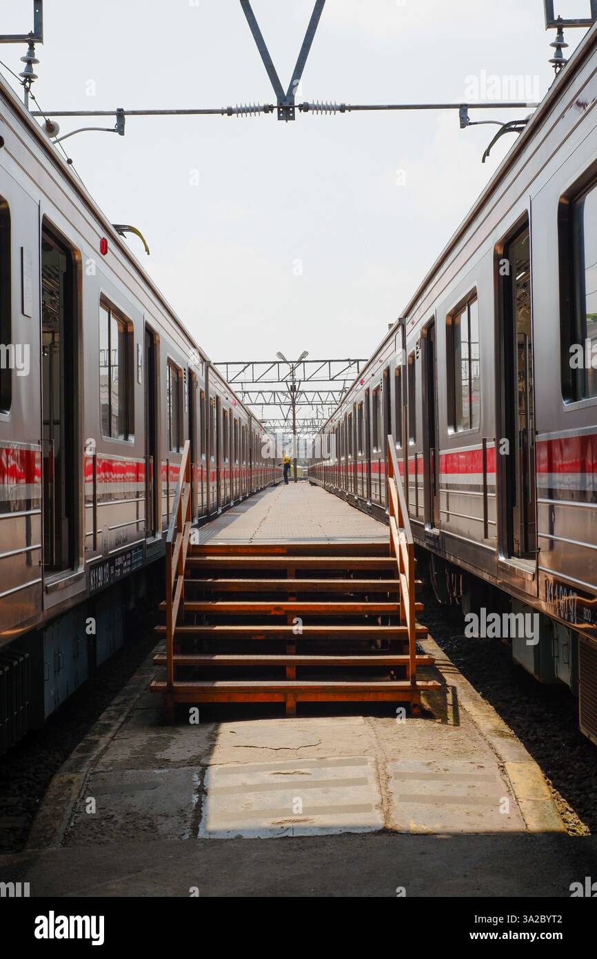 pedestrian path inside the station in the middle between two cars of a ...