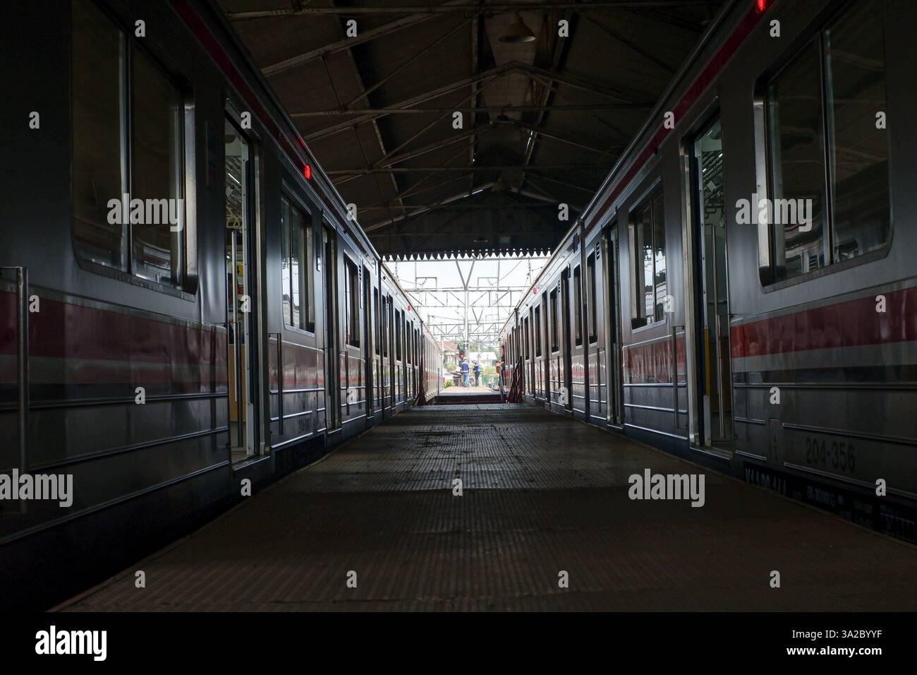 pedestrian path inside the station in the middle between two cars of a ...