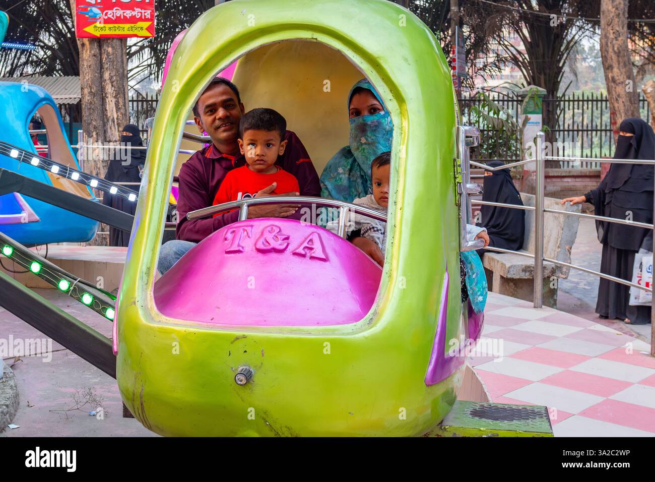 Bangladeshi family taking a ride in an amusement park, Comilla ...